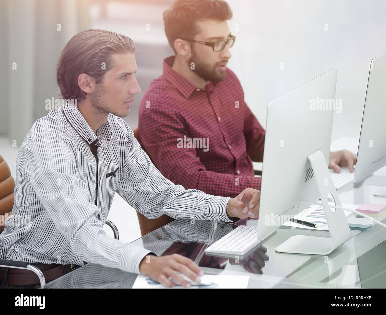 Two employees , sitting in front of computer Stock Photo - Alamy