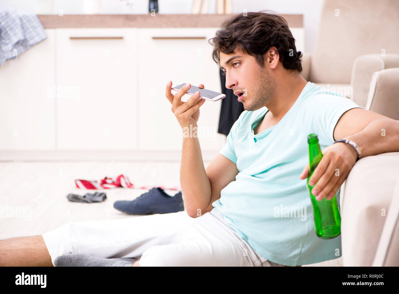 Young drunk handsome man after party at home Stock Photo - Alamy