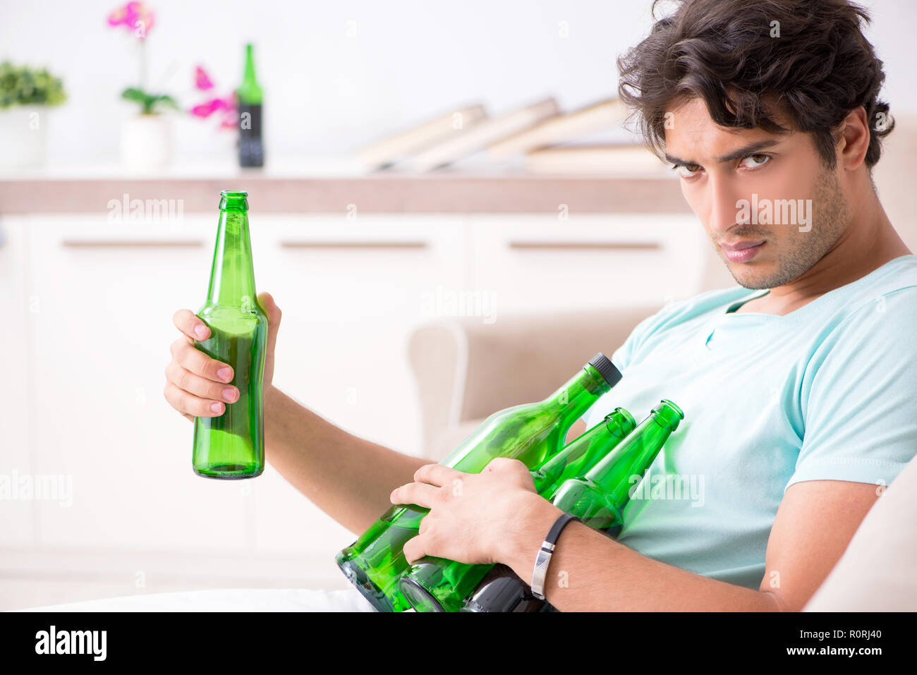 Young drunk handsome man after party at home Stock Photo - Alamy