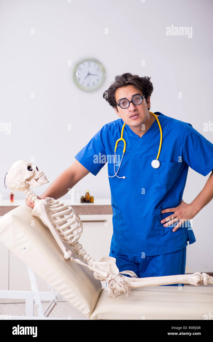 Funny doctor with skeleton in hospital Stock Photo - Alamy