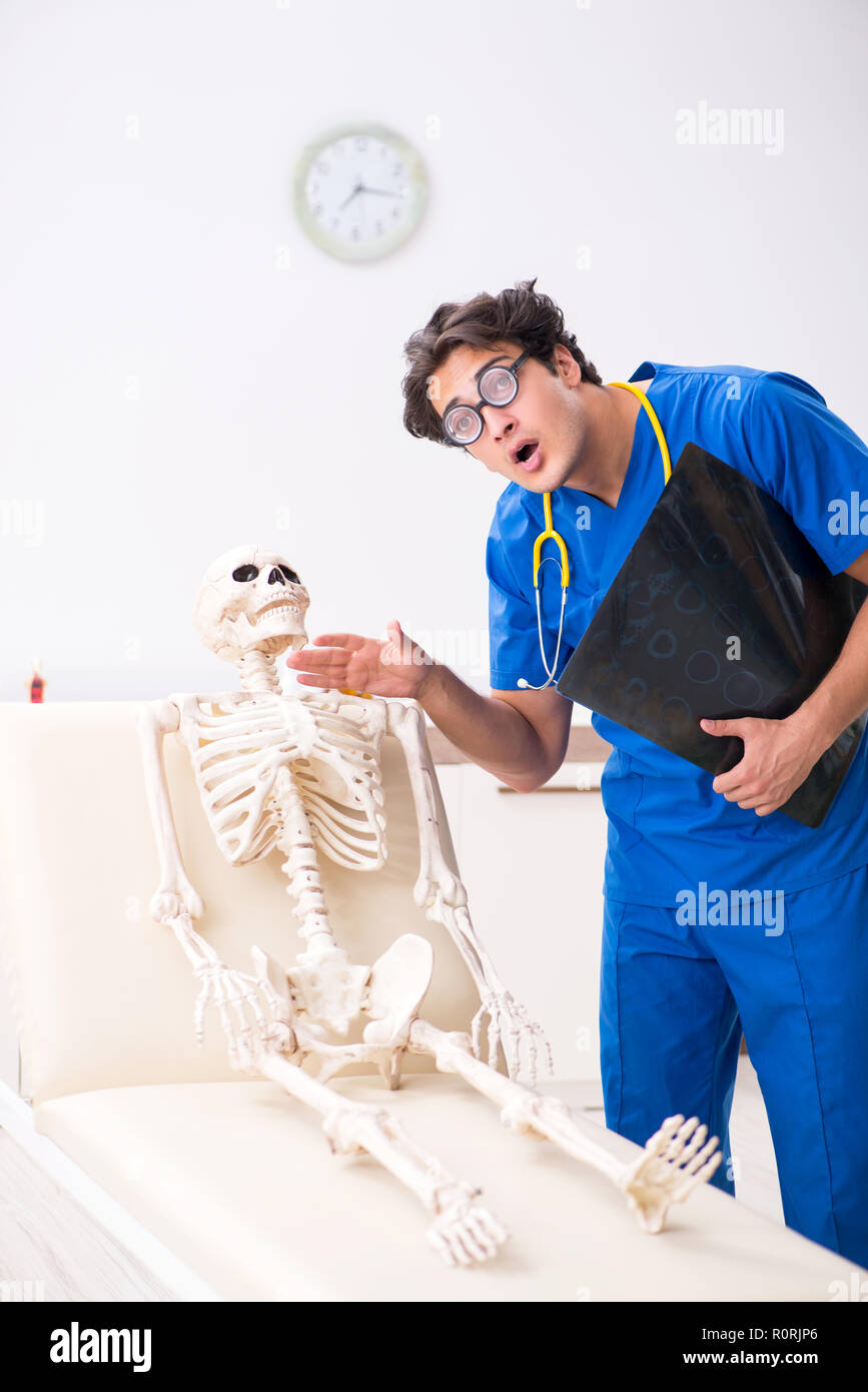 Funny doctor with skeleton in hospital Stock Photo - Alamy