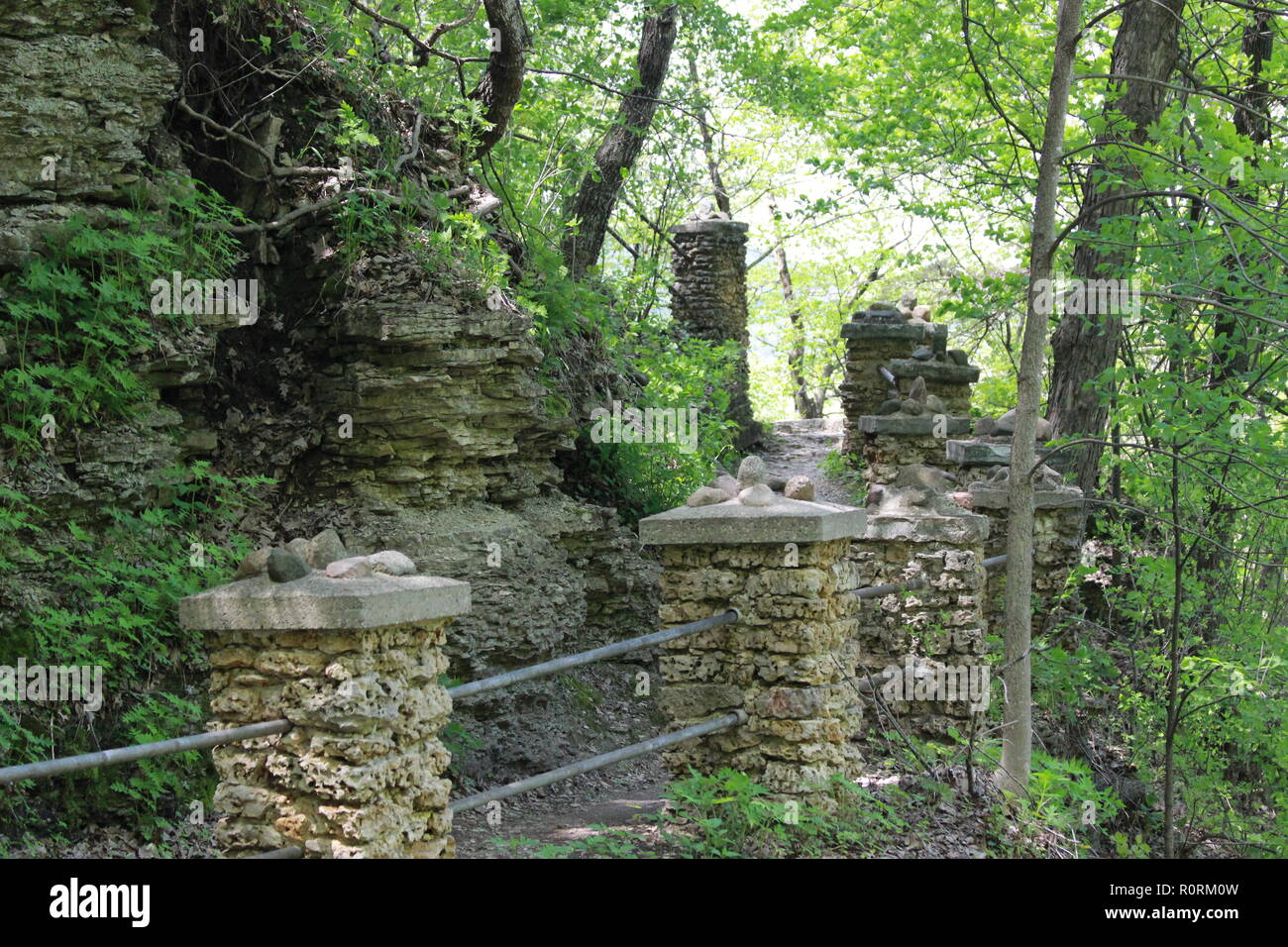 Trail with a stone rail through the forest Stock Photo - Alamy