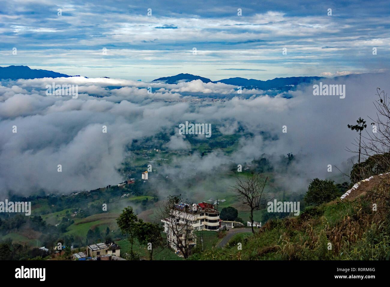 Above the early morning clouds in the Himalayan foothills outside of ...