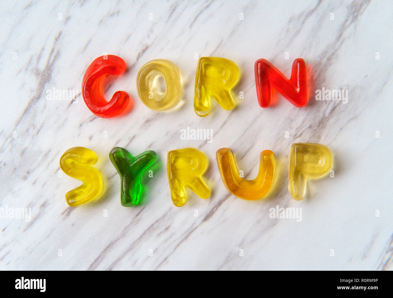 Assorted colorful gummy candy letters spell the words Corn Syrup Stock ...