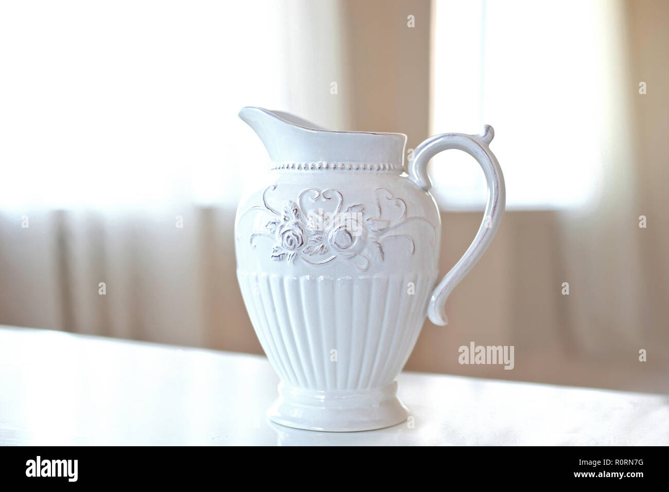 Big white ceramic jug on the table in big bright room Stock Photo - Alamy