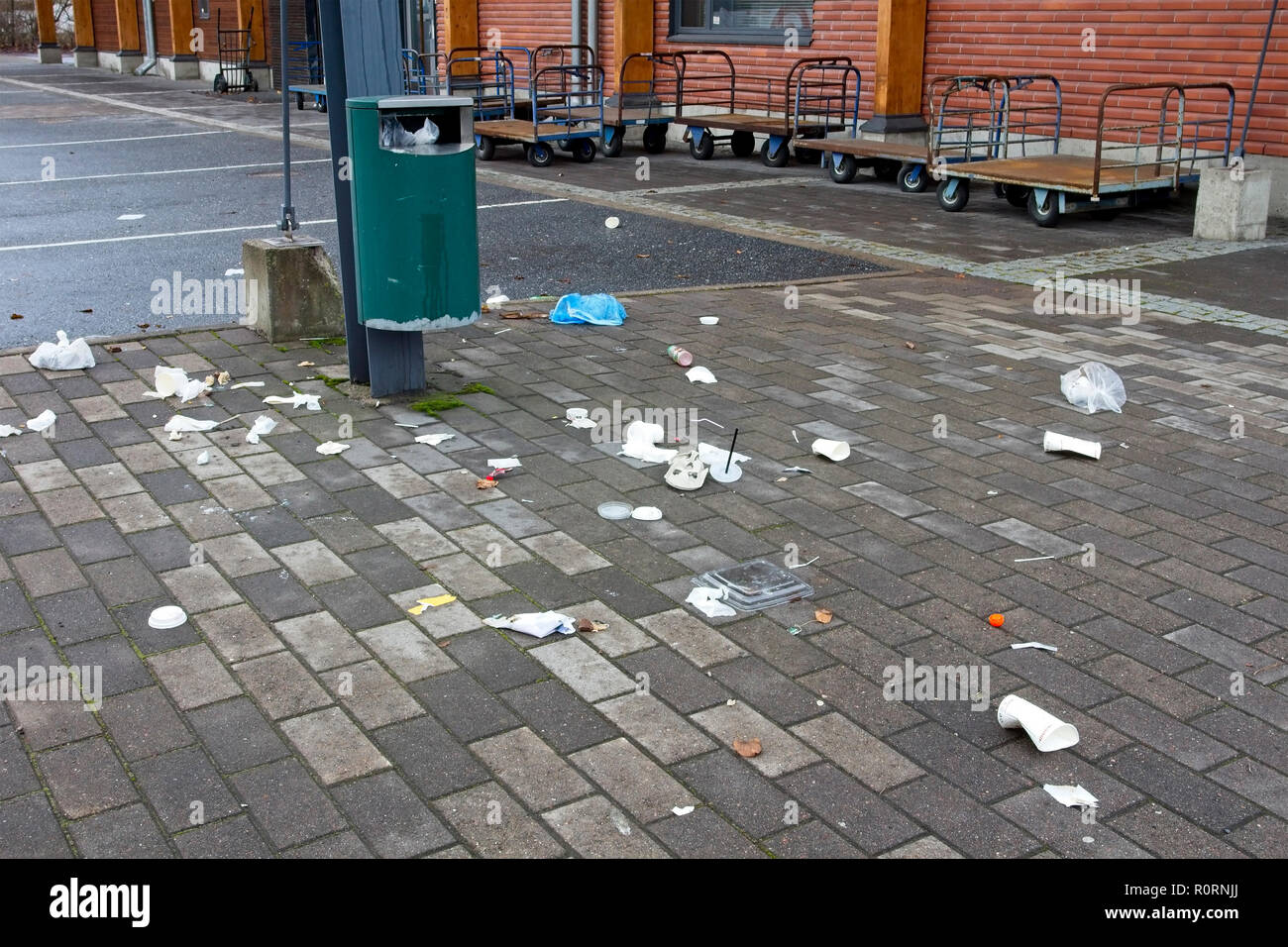 littered area with trashcan Stock Photo - Alamy