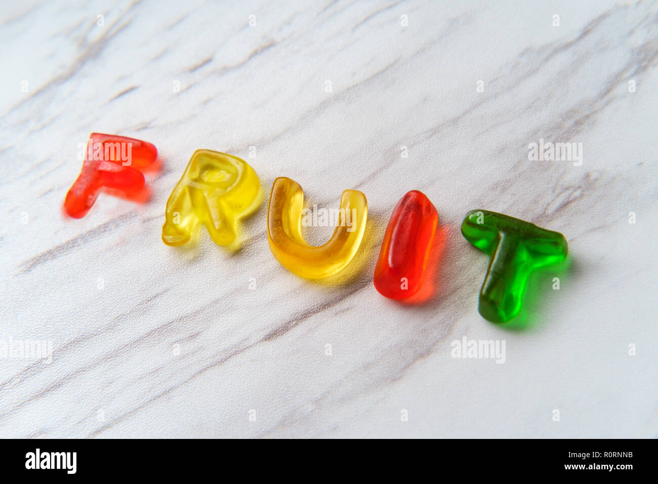 Assorted colorful gummy candy letters spell the word Fruit Stock Photo ...