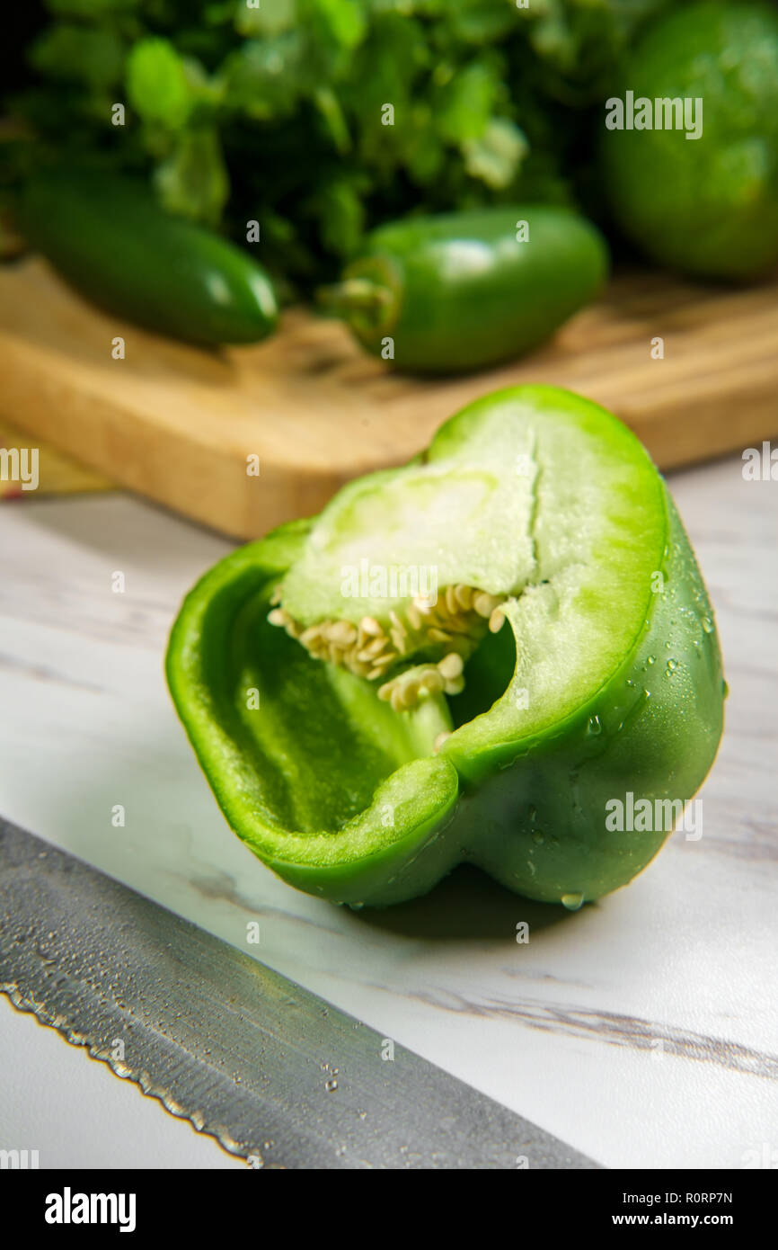 Green bell pepper sliced in half showing seeds and pith Stock Photo - Alamy