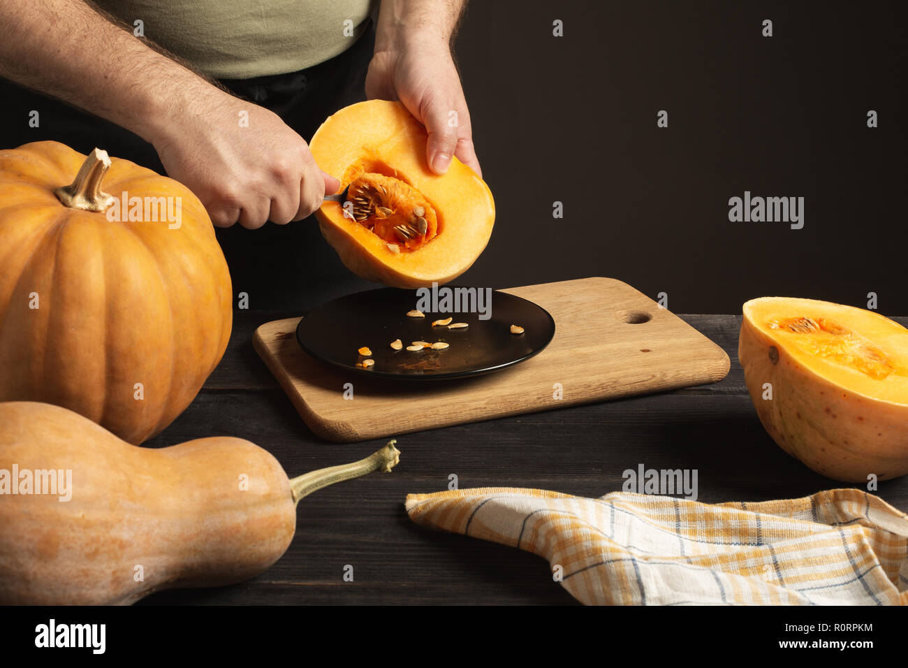 The cook separates the grain from the pumpkin cut in half Stock Photo ...