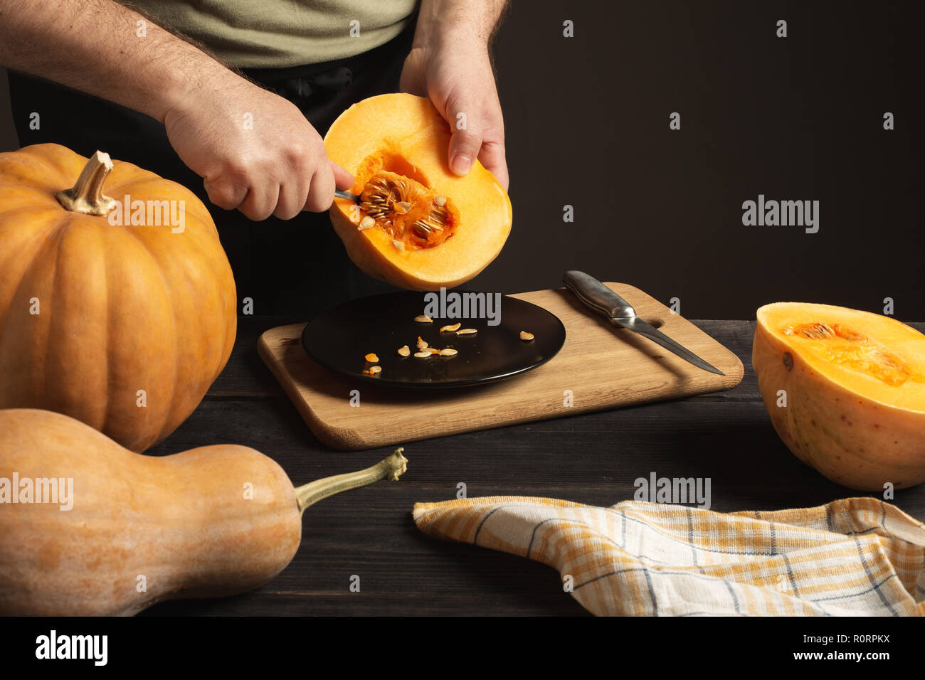 The cook separates the grain from the pumpkin cut in half Stock Photo ...