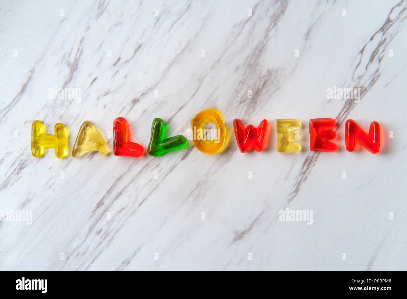 Assorted colorful gummy candy letters spell the word Halloween Stock ...