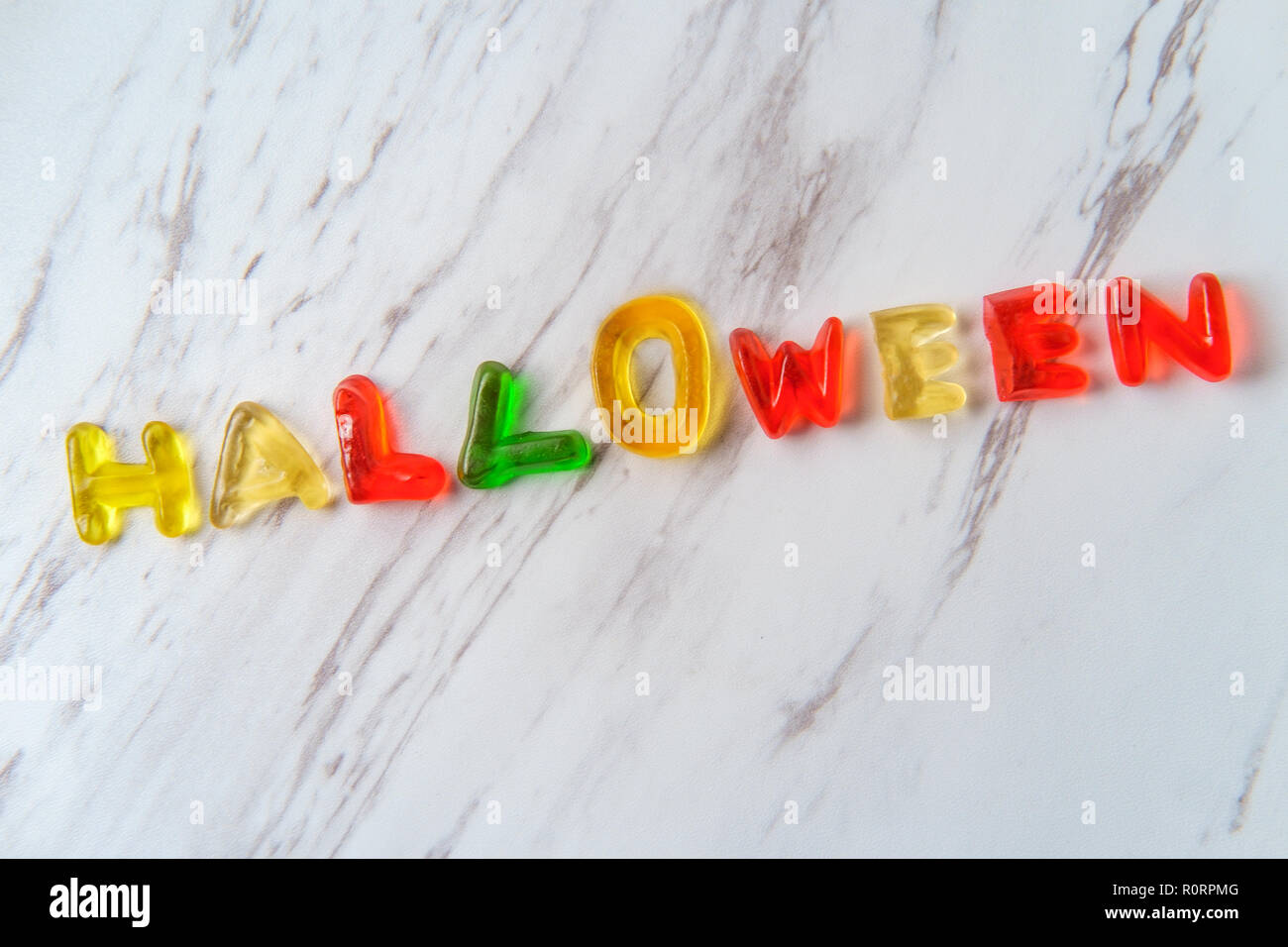 Assorted colorful gummy candy letters spell the word Halloween Stock ...