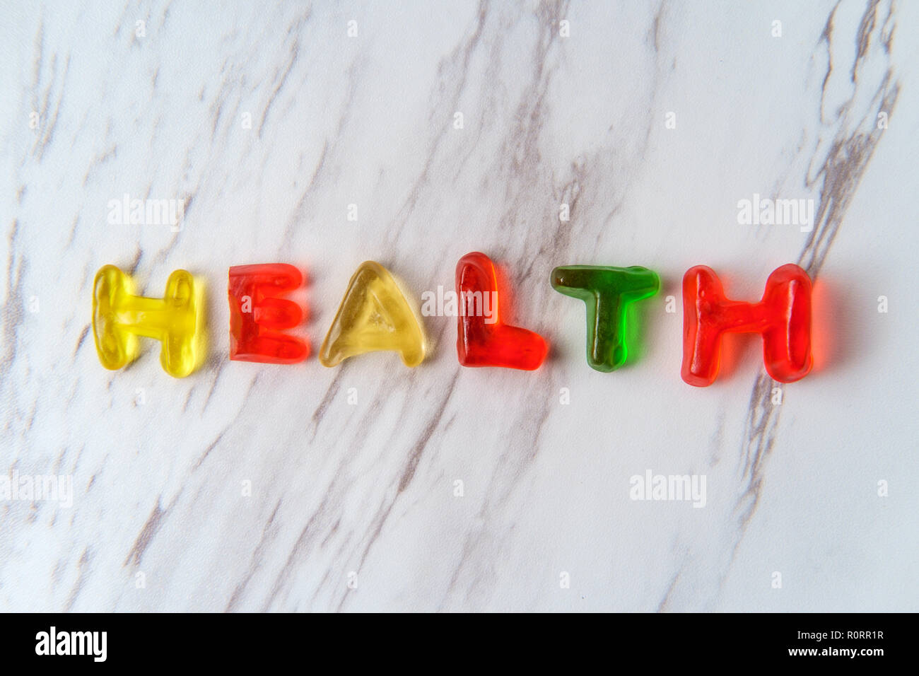 Assorted colorful gummy candy letters spell the word Health Stock Photo ...