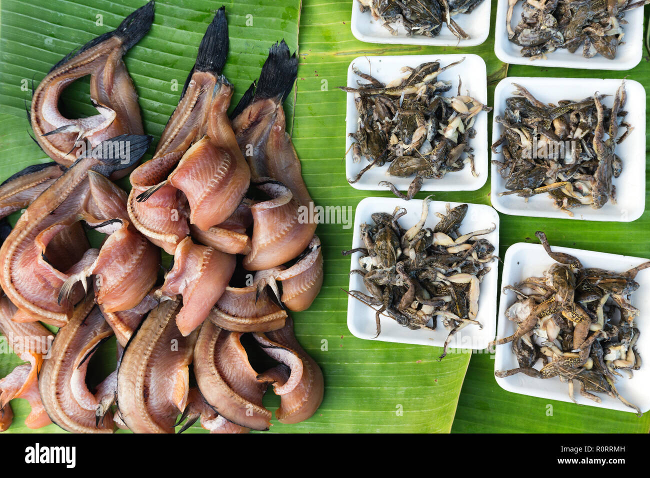 Cooked frogs and fresh kipper in a tropical asian market in Thailand ...