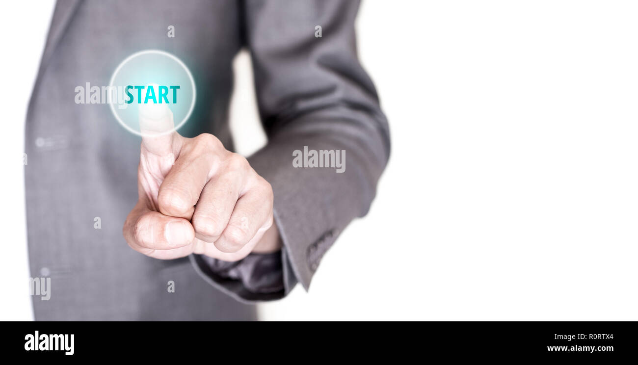 Businessman in gray suit pushing start button on touch screen interface ...