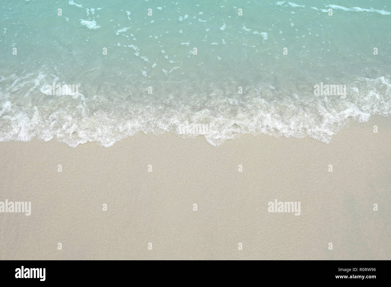 Sea water wave and gold sand on the beach. Holiday and vacation concept ...