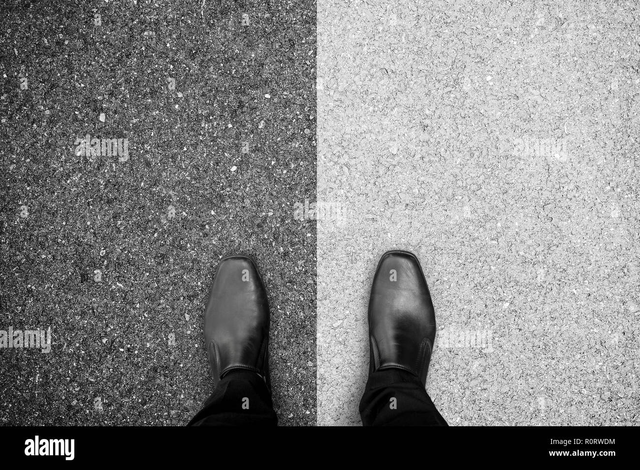 Businessman In Black Shoes Standing Between Black And White Concrete