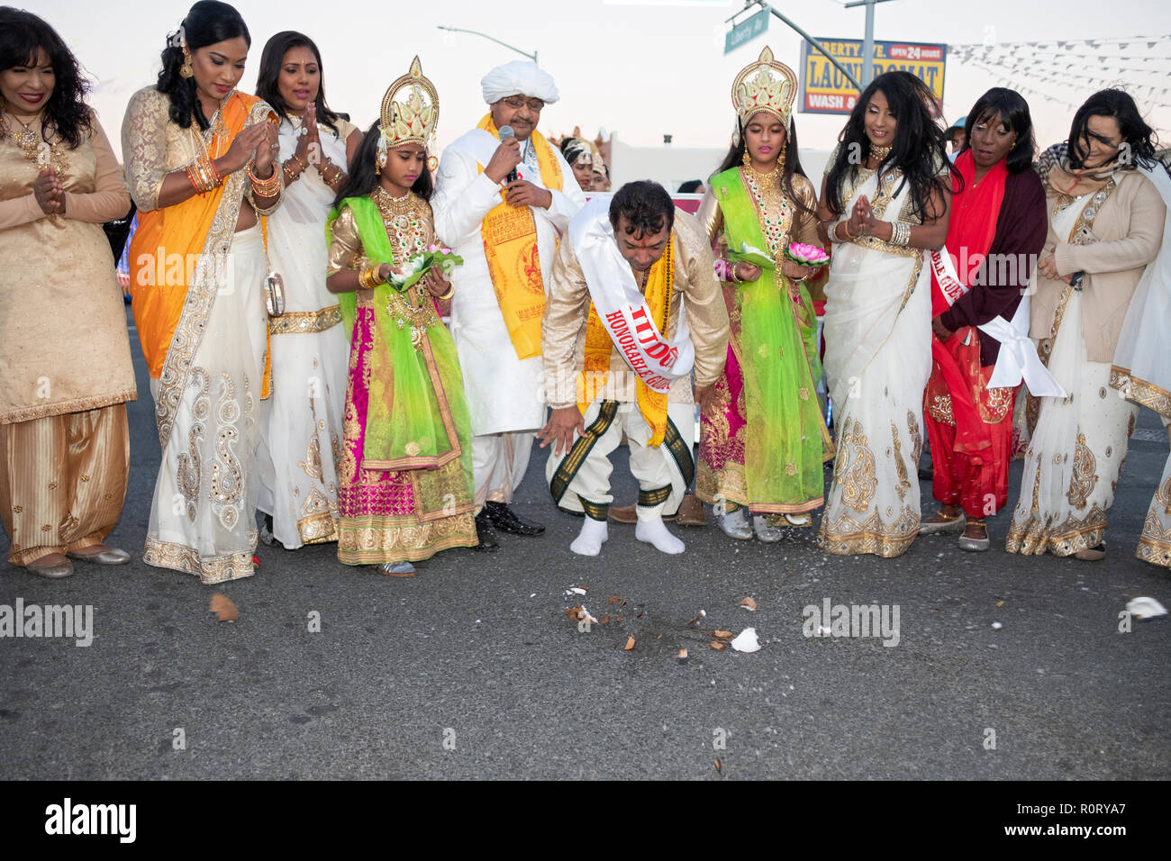 Participants in the Diwali motorcade, smash a coconut symbolizing ...
