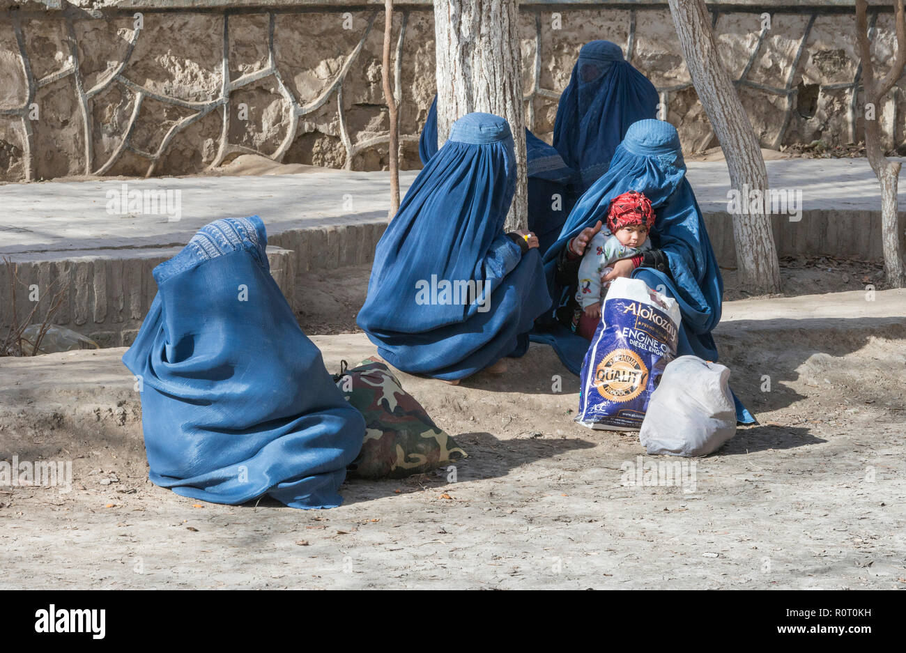 Three Women And A Child Wearing Traditional Blue Burqa Relaxing In A ...