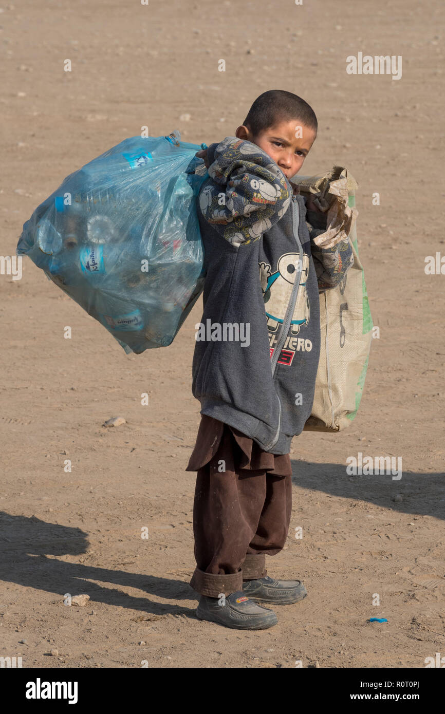 Portrait Of Lonely Poor Young Boy Collecting Garbage In Plastic Bags To ...