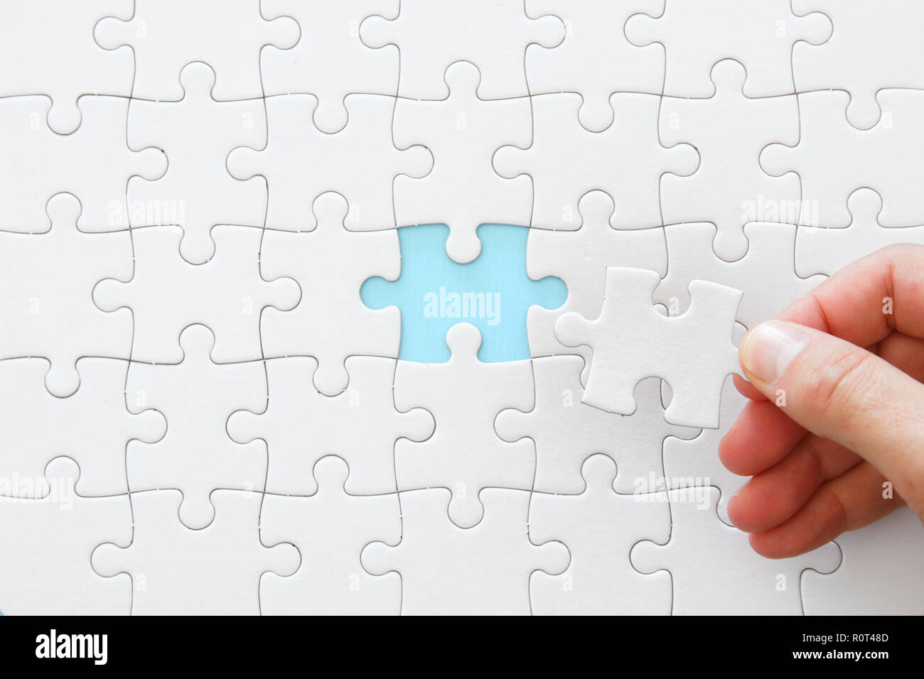Hand putting last piece hi-res stock photography and images - Alamy