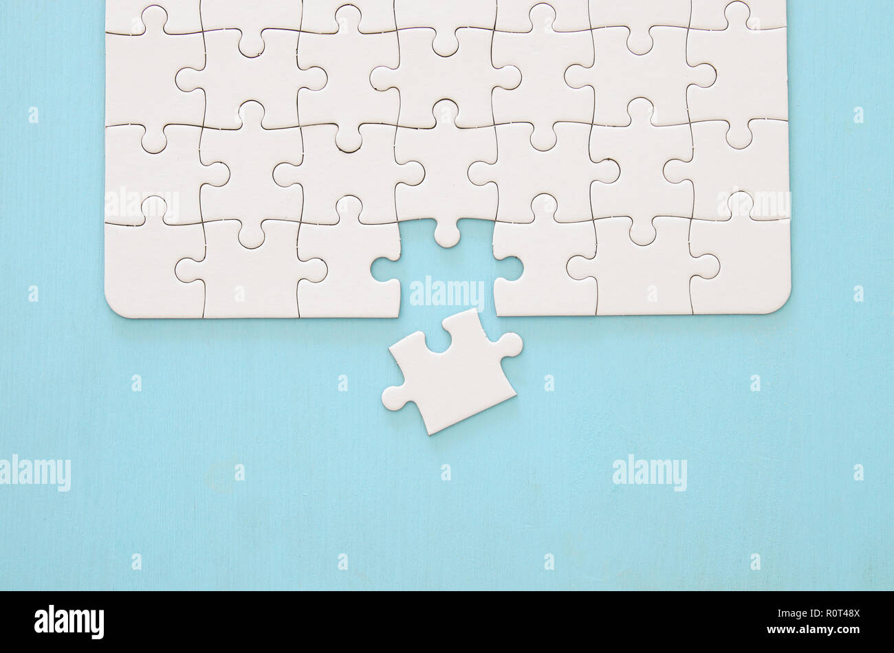 background of white puzzle with missing piece Stock Photo - Alamy
