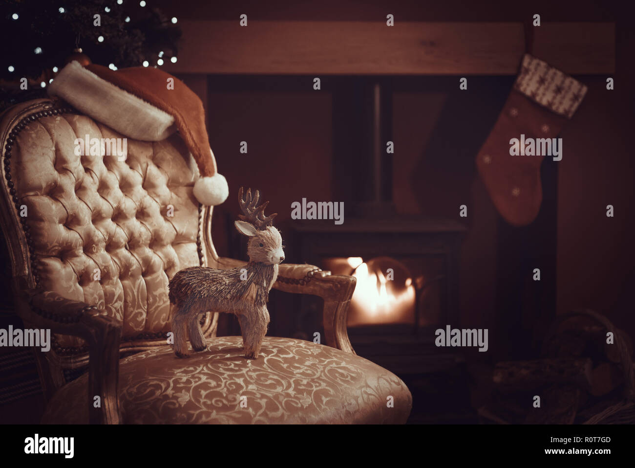 Festive Christmas by a roaring log fire and decorated Christmas tree ...