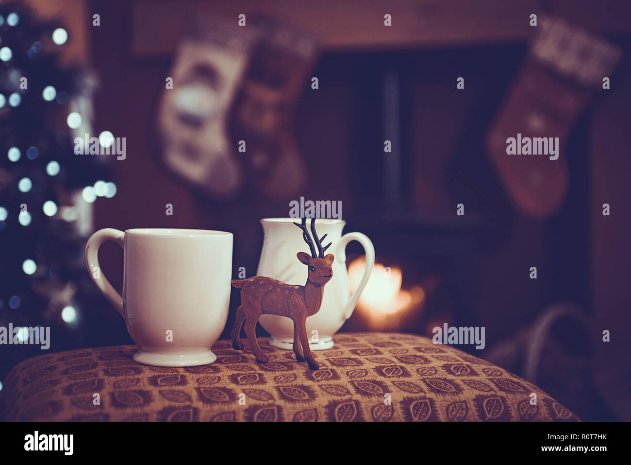 Festive Christmas drinks by a roaring log fire Stock Photo - Alamy