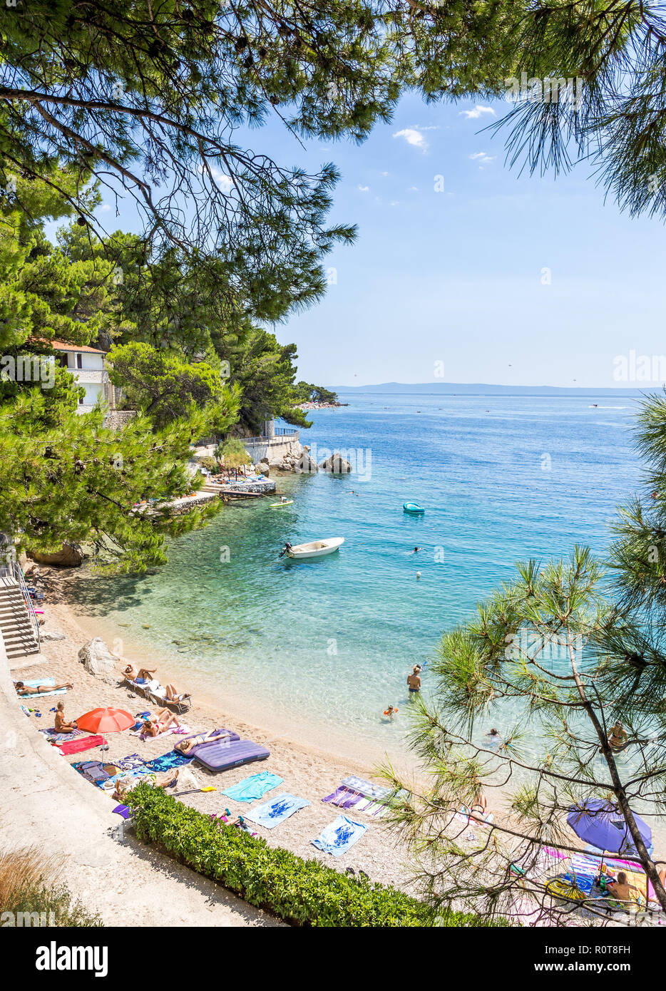 BRELA, CROATIA - JULY 20, 2018: Tourists relaxing on marvelous Brela ...