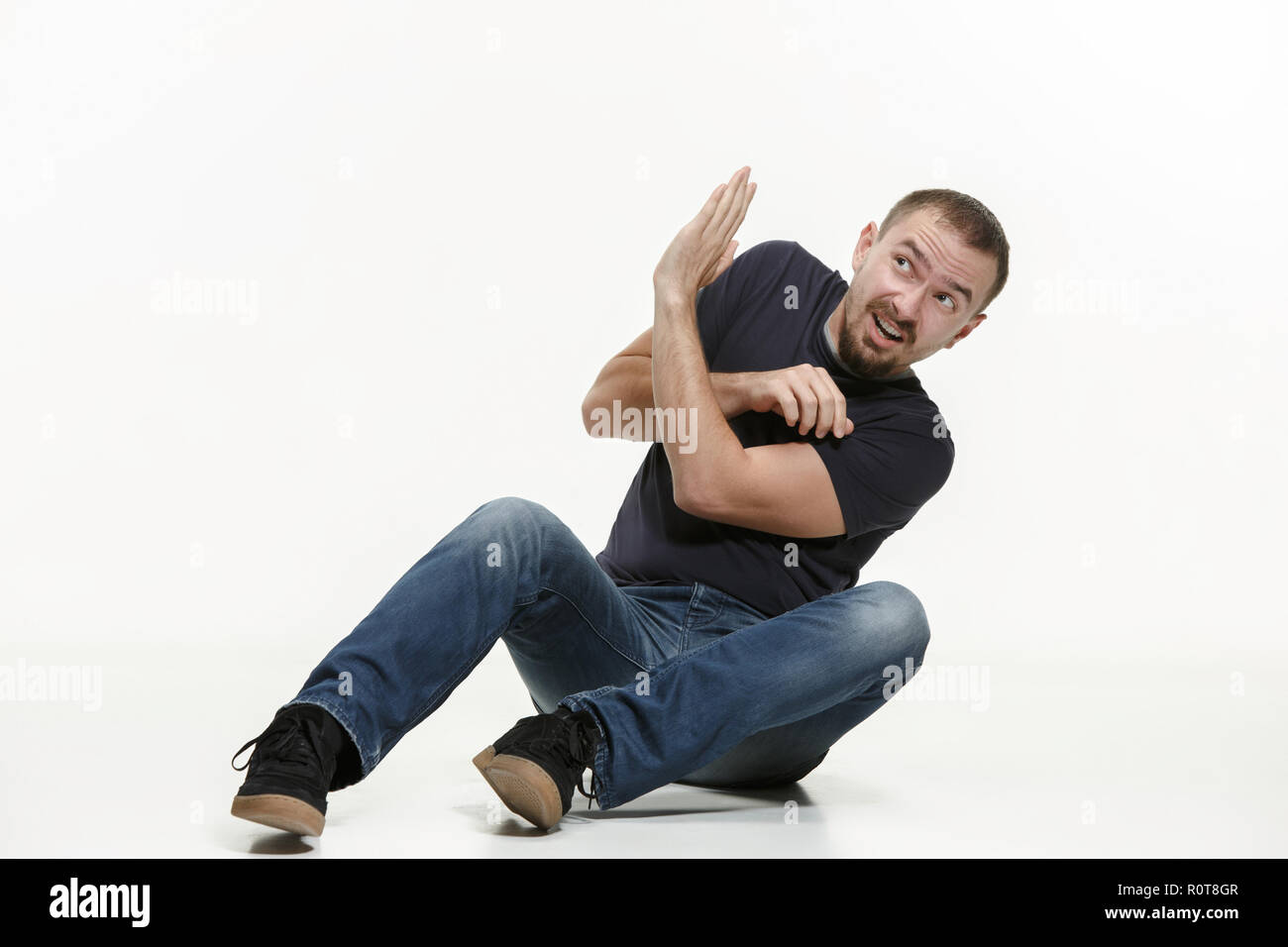 The young cool man full body scared pose at white studio Stock Photo ...