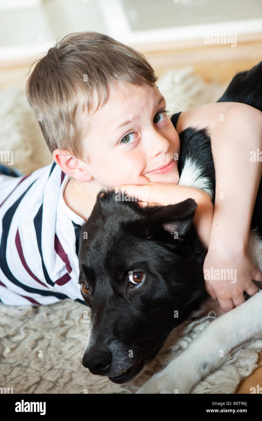 A handsome little boy with ADHD, Autism, Aspergers Syndrome cuddles and ...