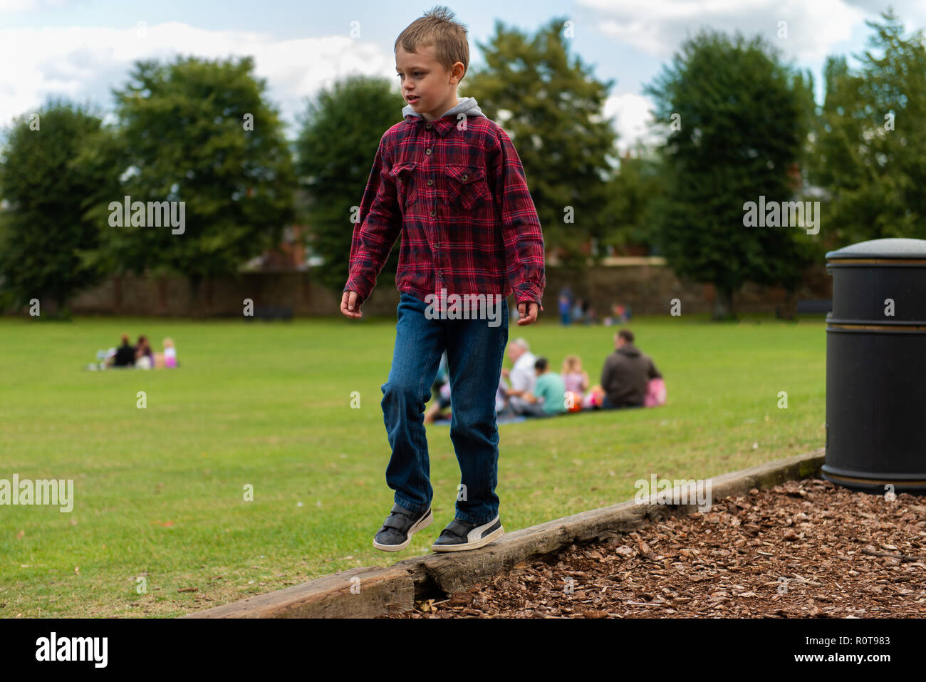 A handsome boy with ADHD, Autism, Asperger Syndrome sitting at the park ...