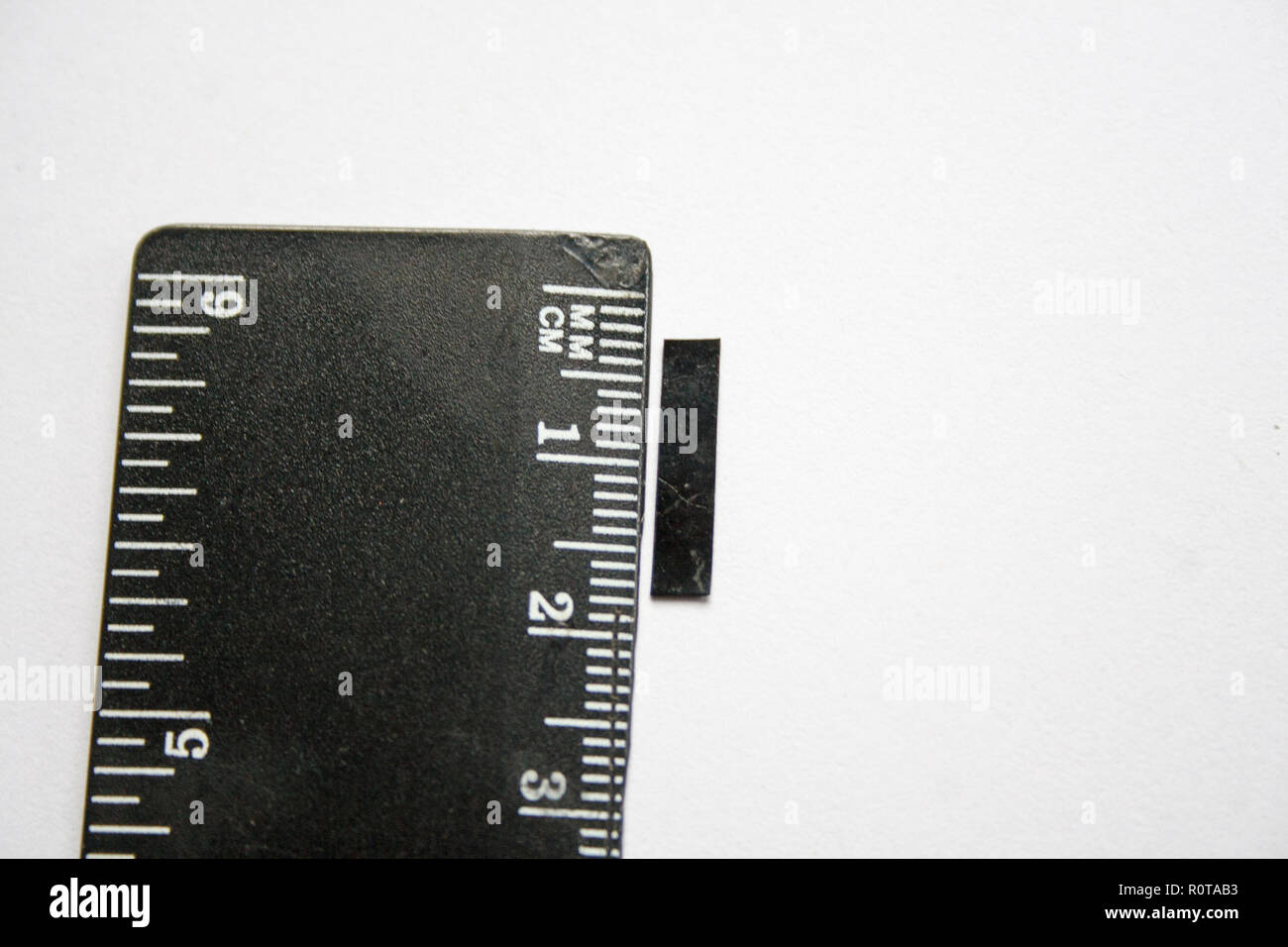 measuring a strip of black material Stock Photo - Alamy
