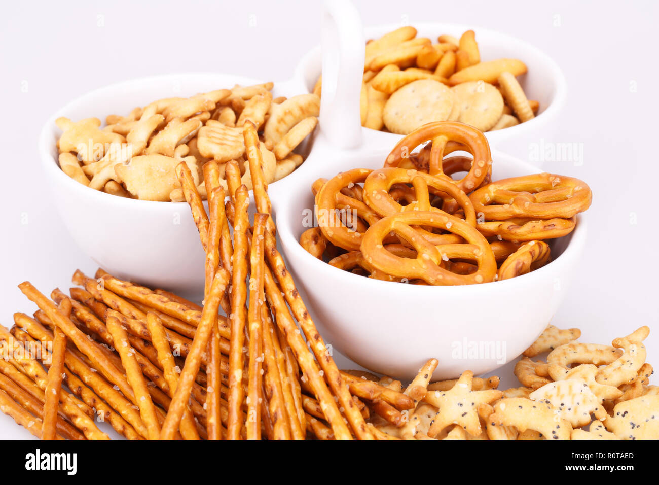 Different salted crackers in bowl on white background Stock Photo - Alamy