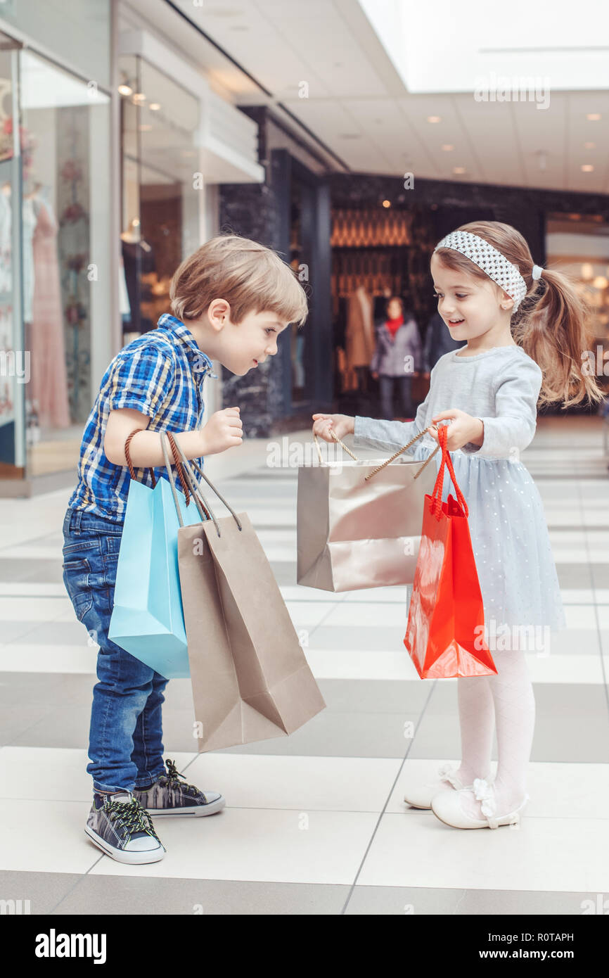 Group portrait of two cute adorable preschool children going shopping ...