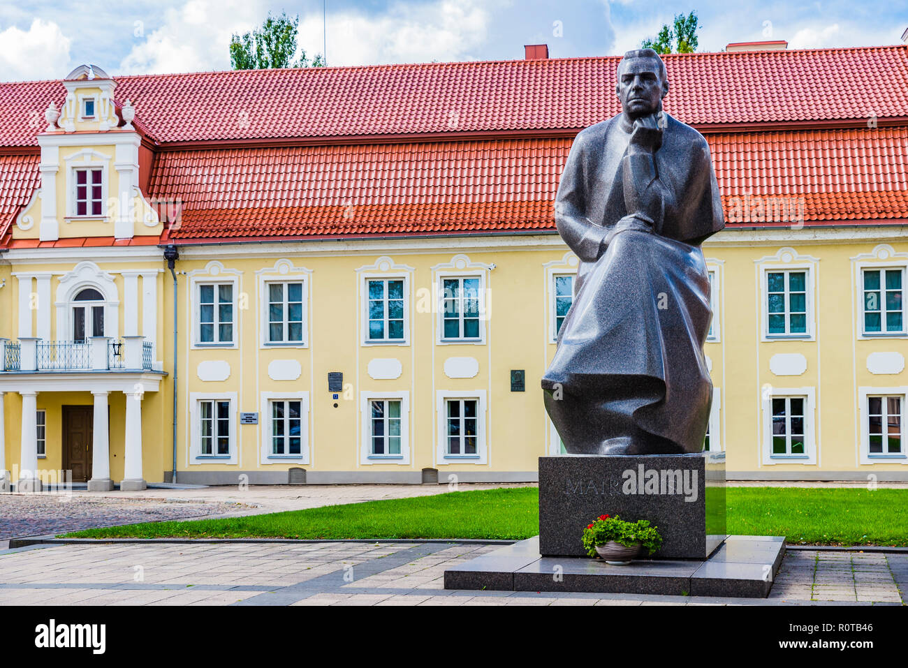 Statue of Maironis, one of the most famous Lithuanian poets. Behind the ...