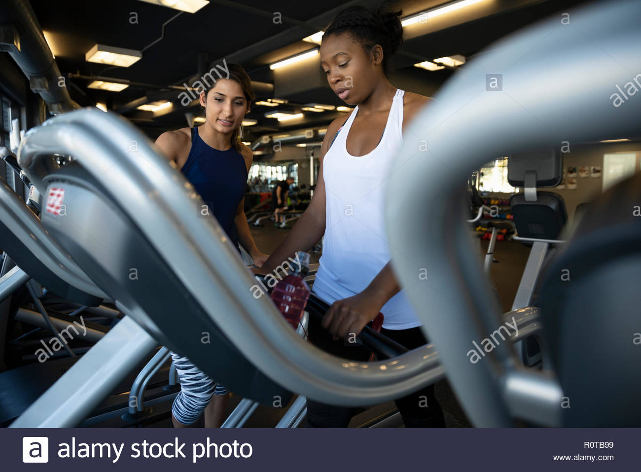 Personal trainer showing woman treadmill hi-res stock photography and ...