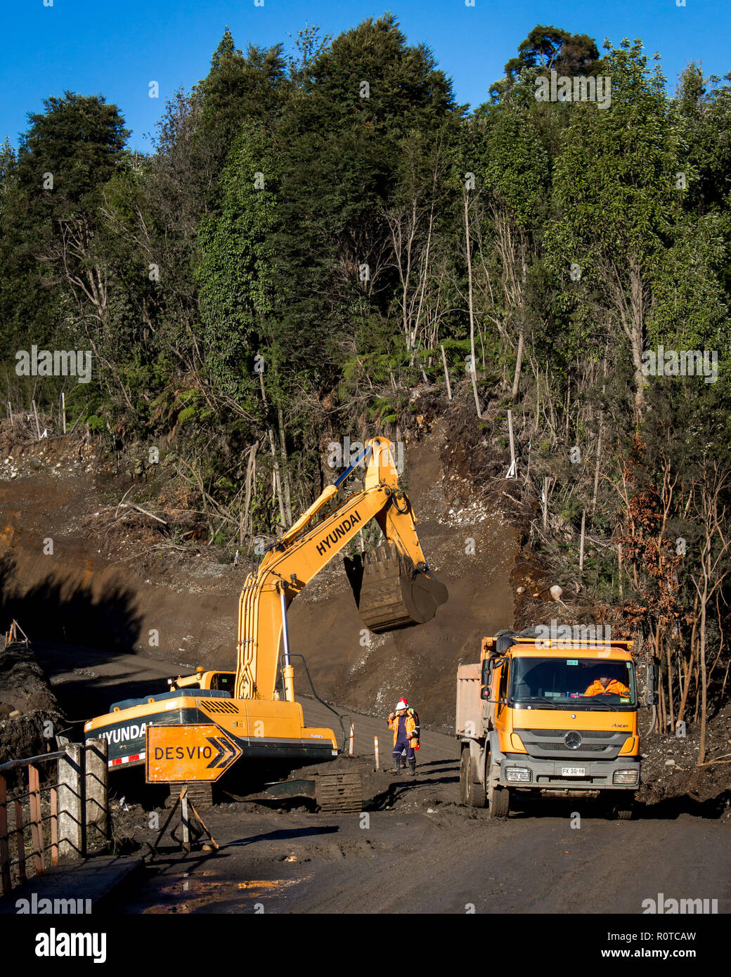 excavator and truck machine working to fix a collapse of the austral ...