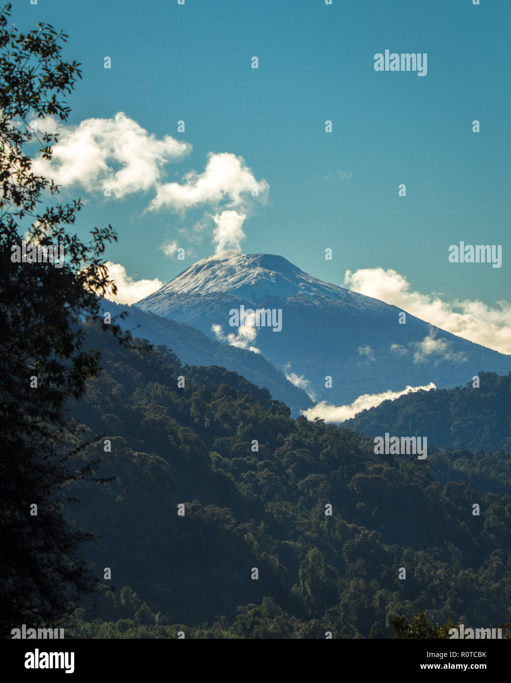 vulcan hornopiren with snowy peak at background at Hornopiren city ...