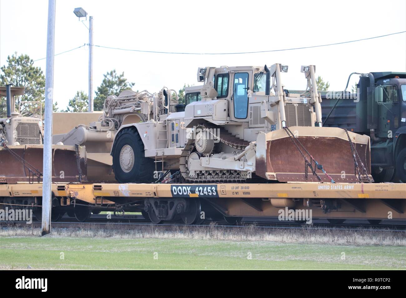 Railcars loaded with Army vehicles and equipment are lined up to be ...