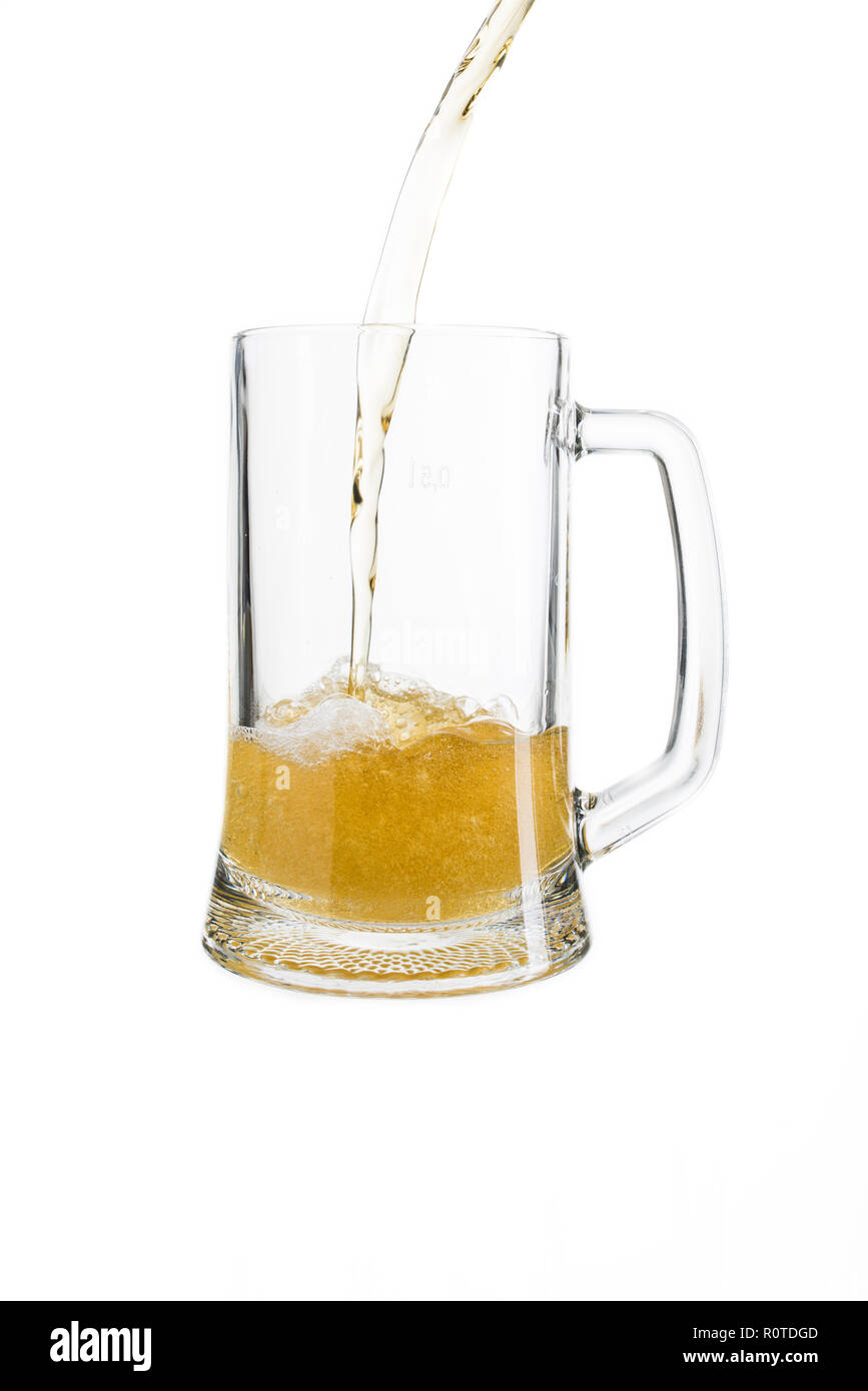 pouring light beer in a glass on an isolated white background Stock ...