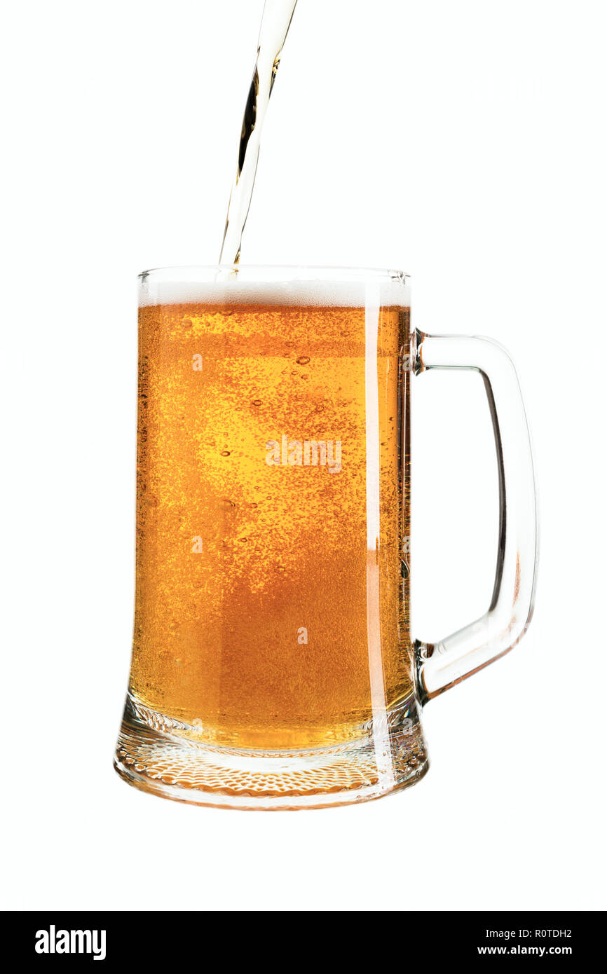 pouring light beer in a glass on an isolated white background Stock ...