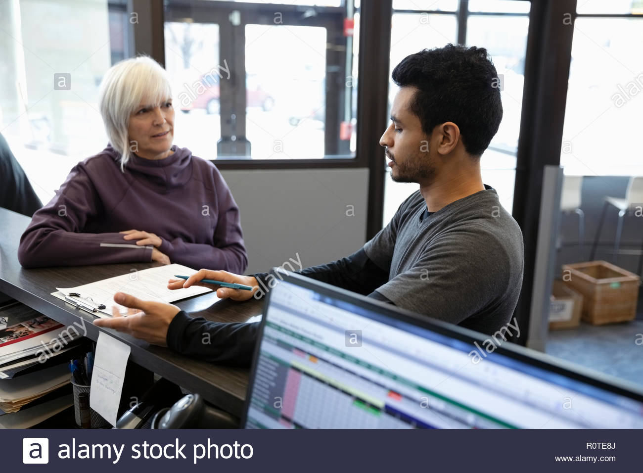 Woman and personal trainer talking hi-res stock photography and images ...