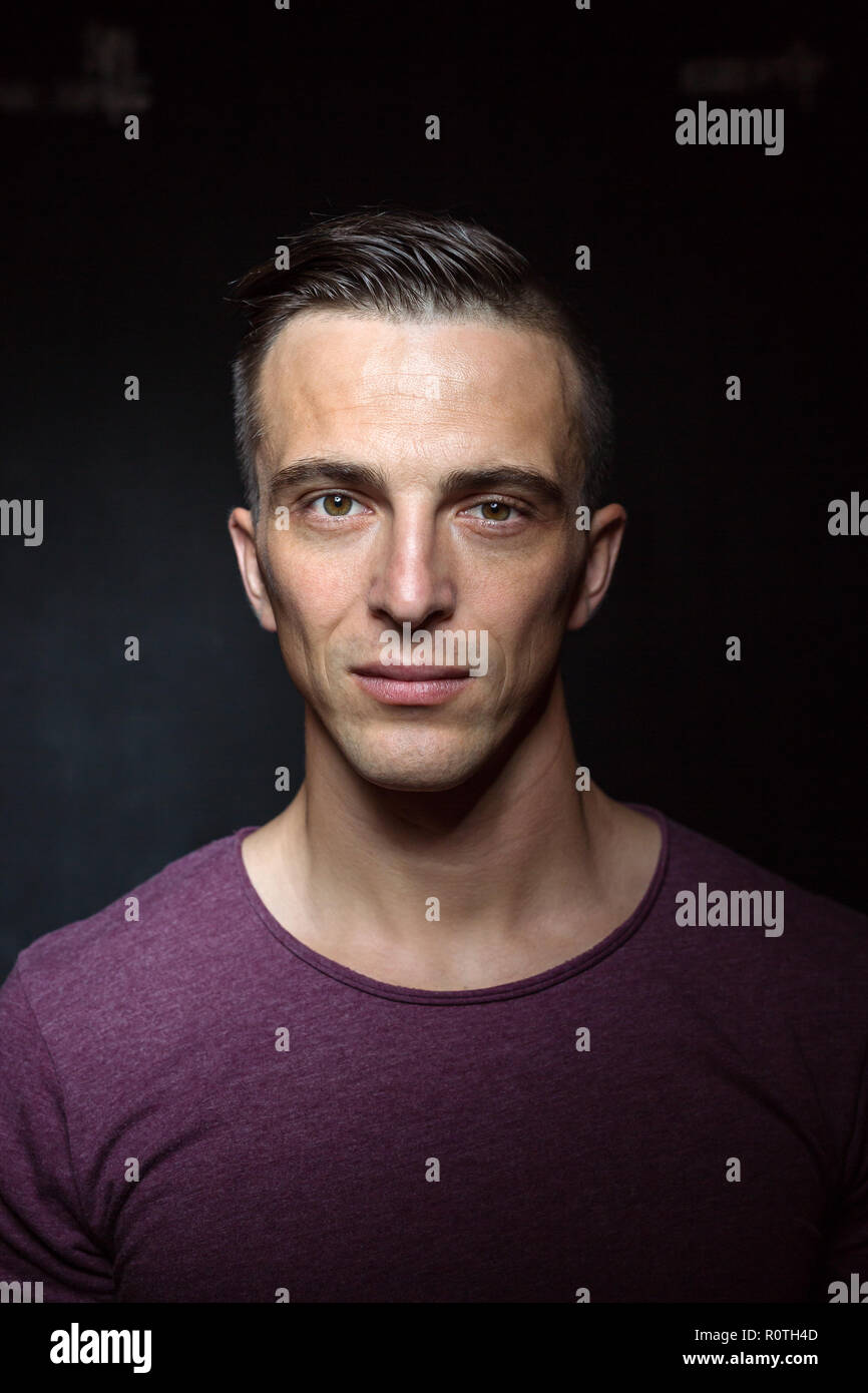Single handsome muscular caucasian man shot in studio, rigid pose and ...