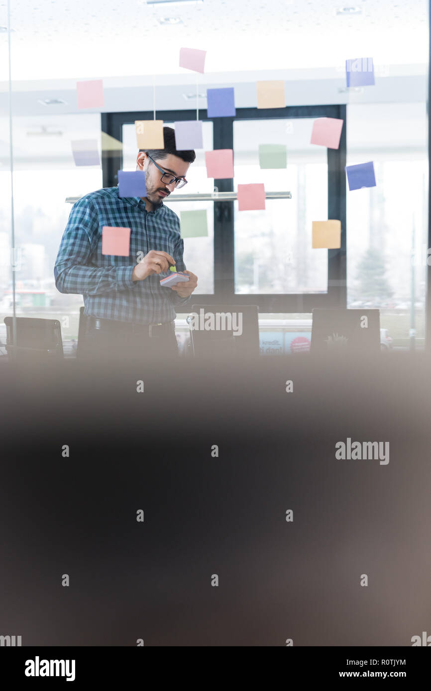 Business people meeting at office and use post it notes to share idea ...