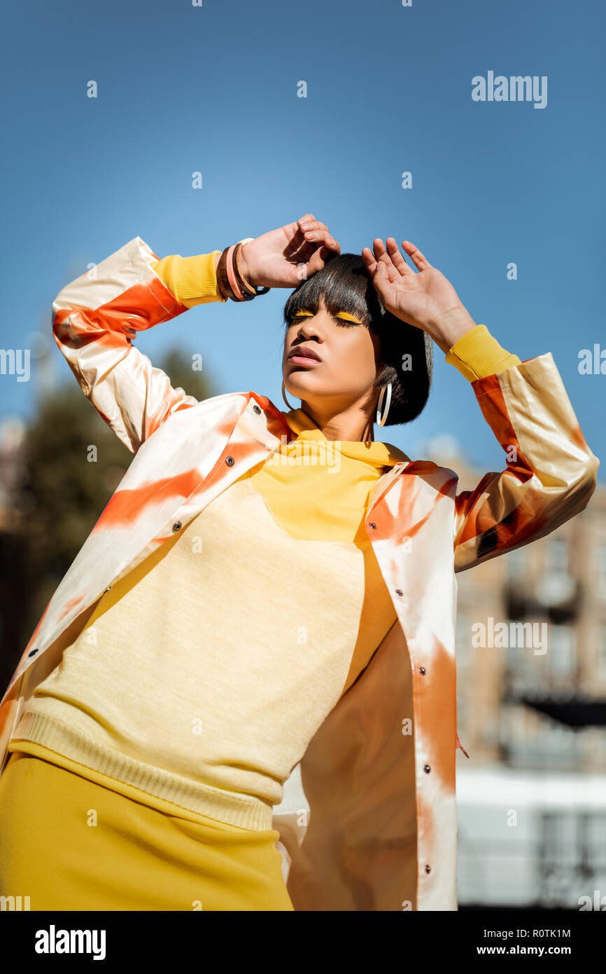 Appealing young lady staying under the sun lights Stock Photo - Alamy