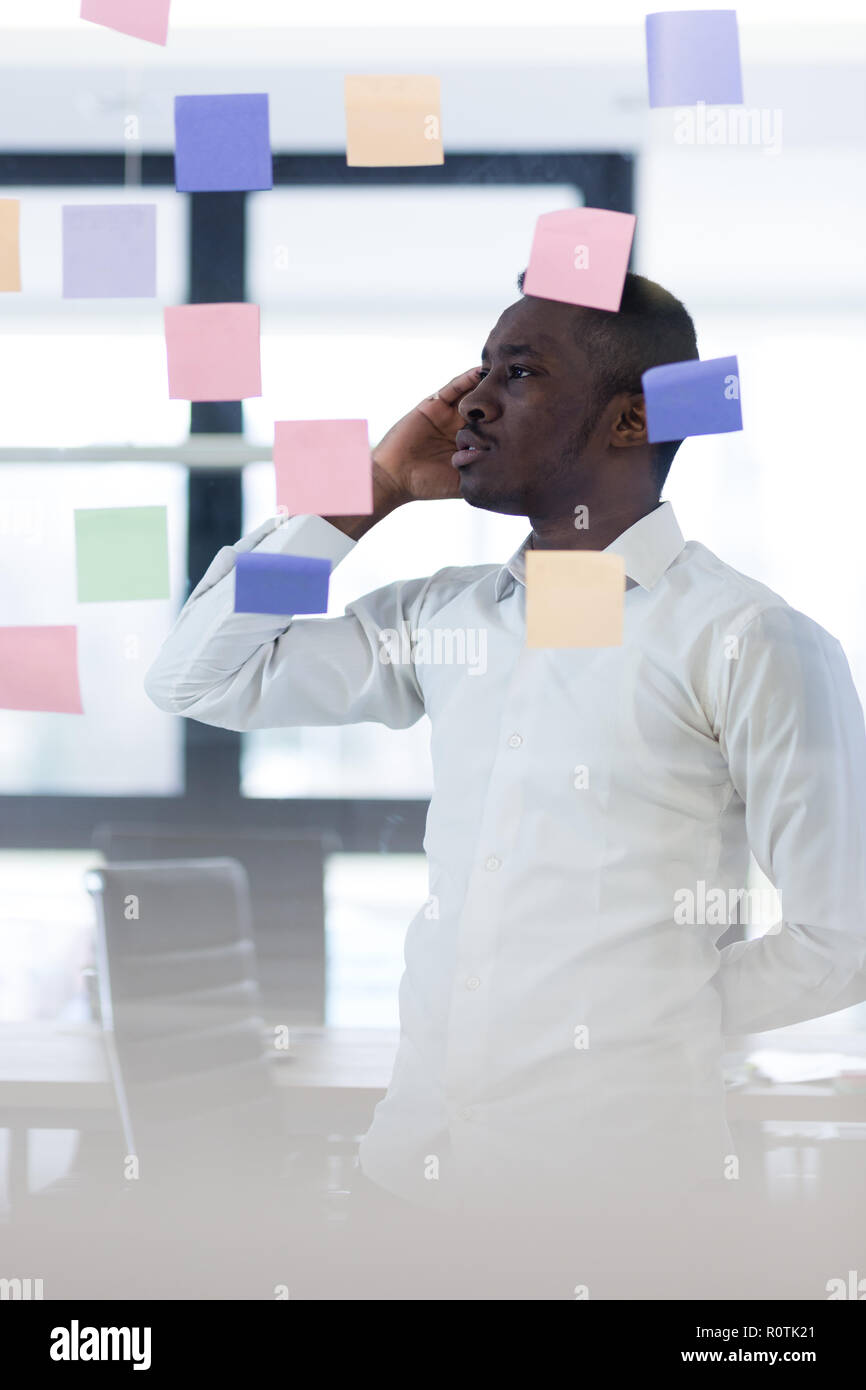 Business people meeting at office and use post it notes to share idea ...