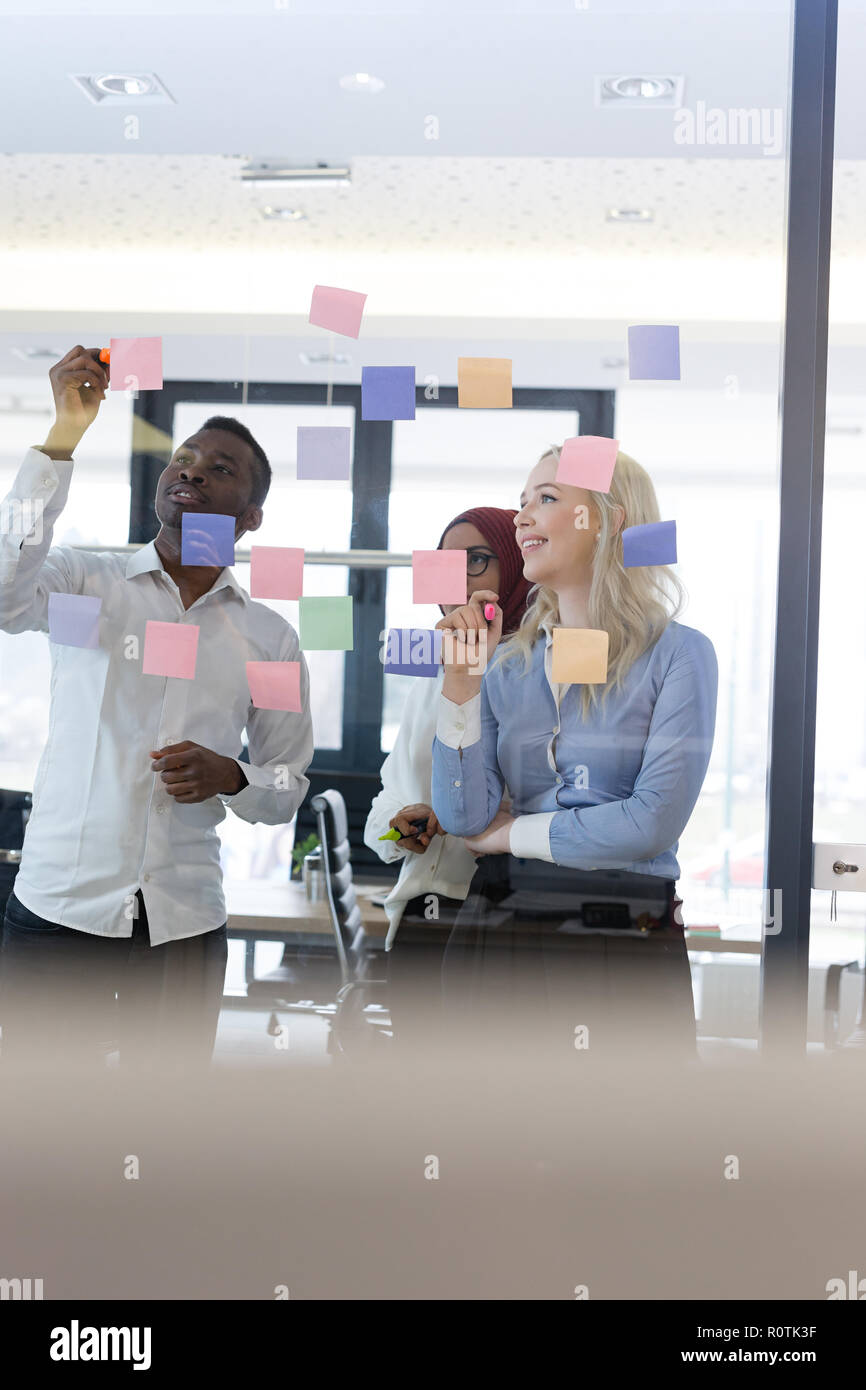 Business people meeting at office and use post it notes to share idea ...