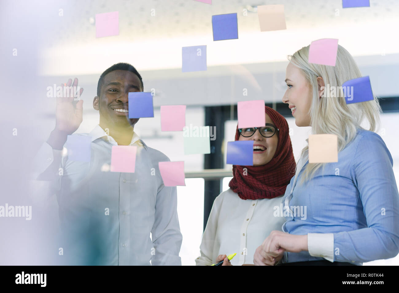 Business people meeting at office and use post it notes to share idea ...