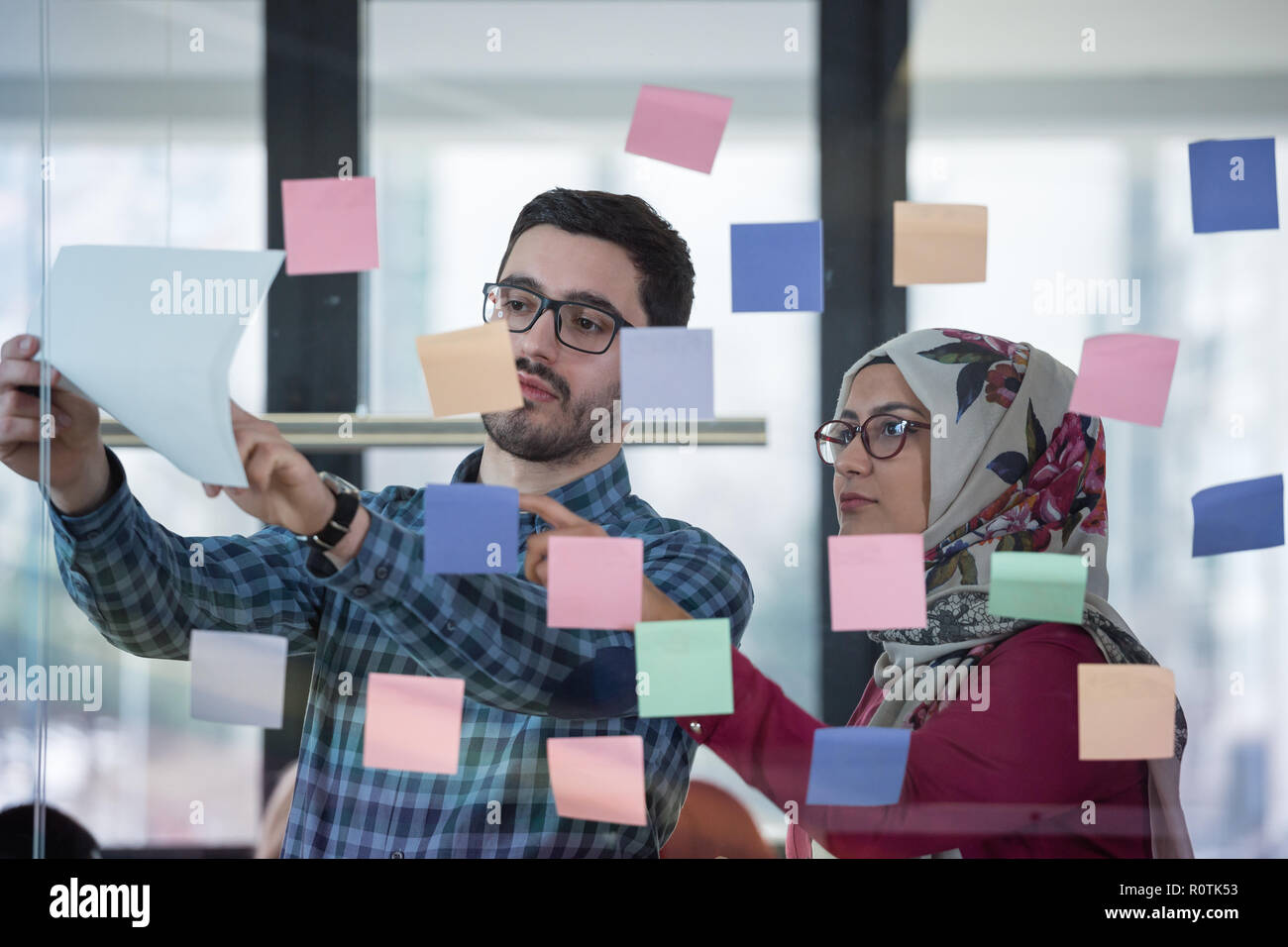 Business people meeting at office and use post it notes to share idea ...